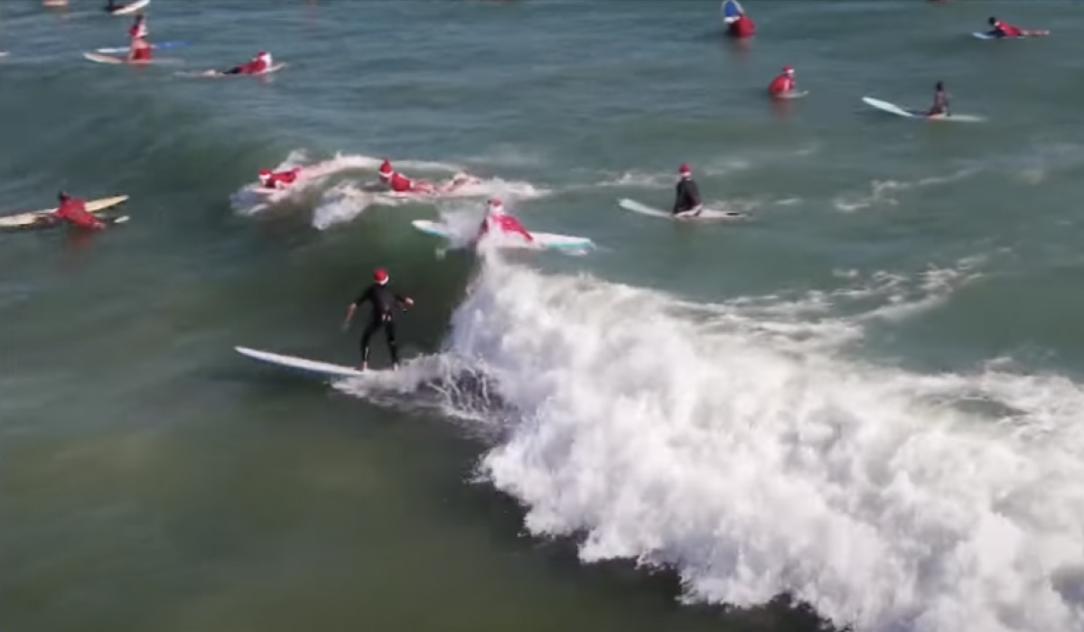Surfing Santas Hit the Waves Amidst Florida Freeze